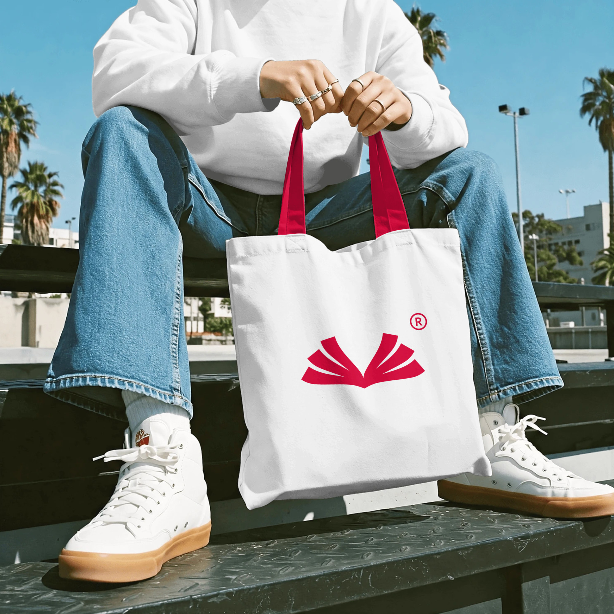 Man wearing sweatshirt and holding canvas bag VI logo mockup rendering ...
