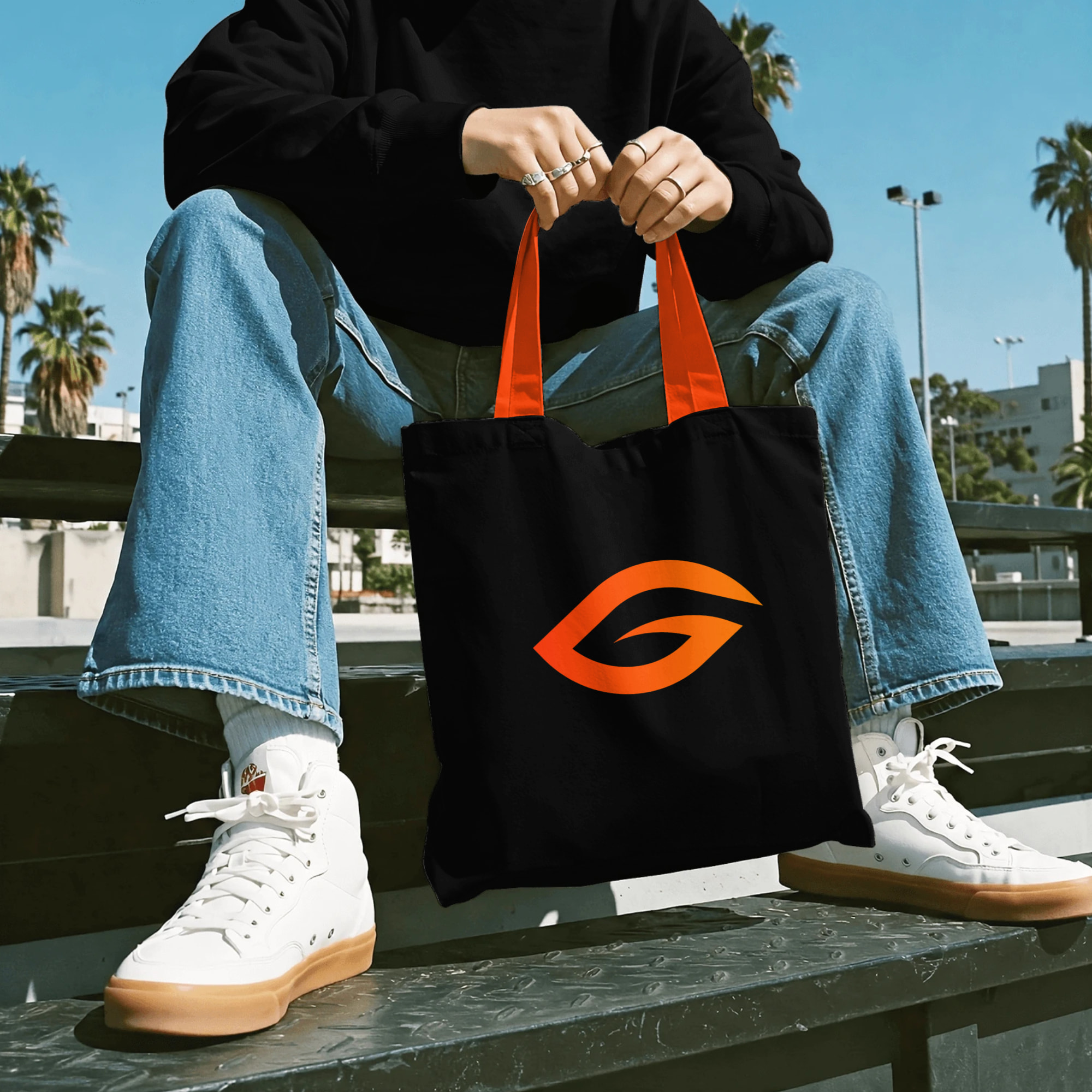 Man wearing sweatshirt and holding canvas bag VI logo mockup rendering ...